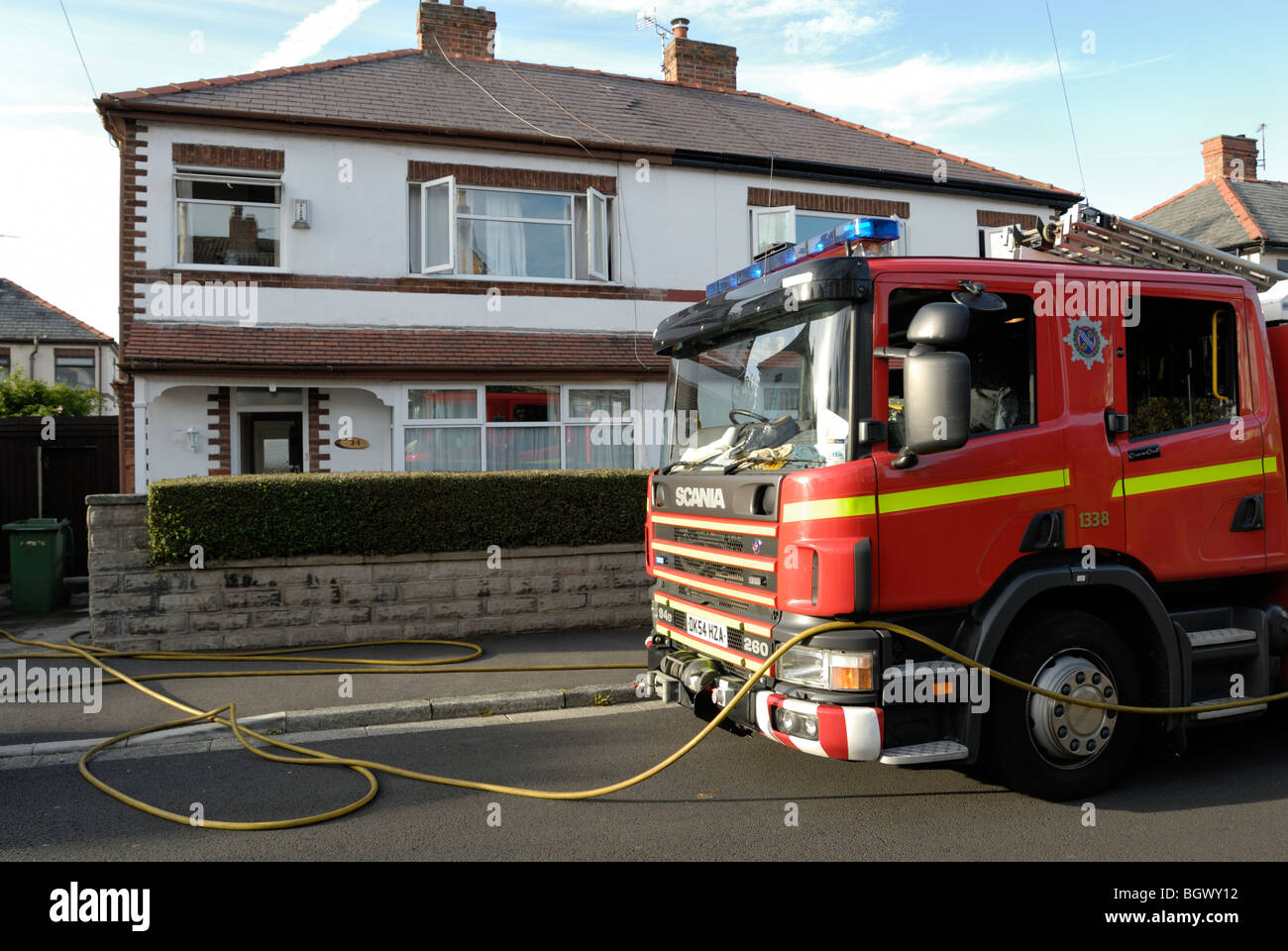 Fire engine outside house with bedroom on fire Stock Photo - Alamy