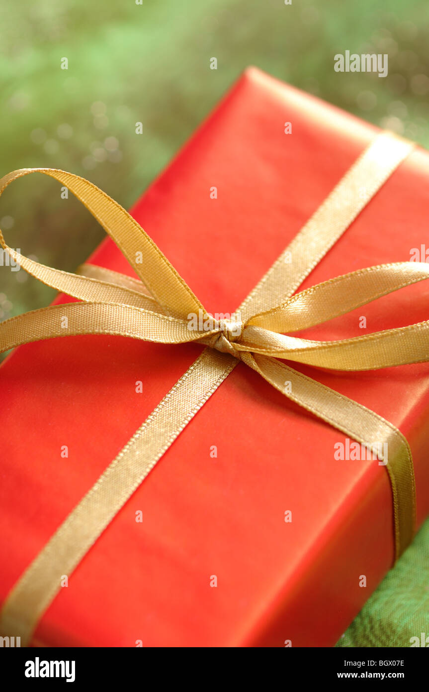 Red present with golden ribbon Stock Photo - Alamy