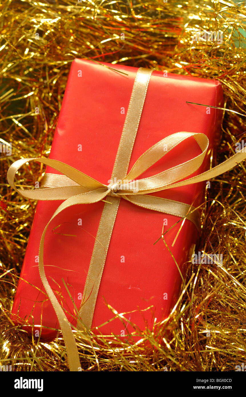 Red present with golden ribbon Stock Photo - Alamy