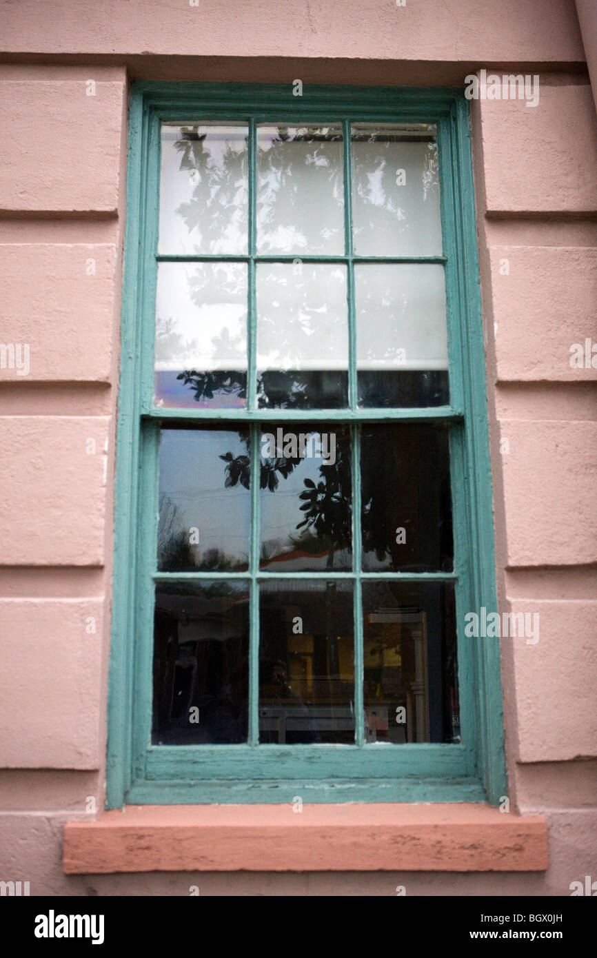 Trim of window painted haint blue on a pink building to ward off ghosts ...