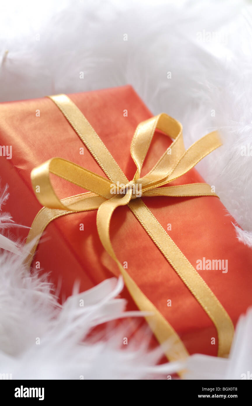 Red present with golden ribbon Stock Photo - Alamy