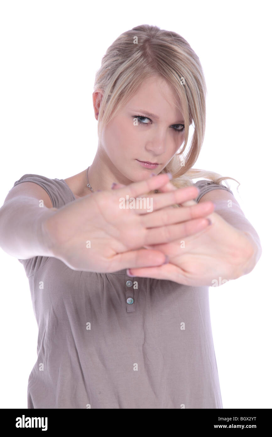 An attractive young woman makes a repelling gesture. All on white ...