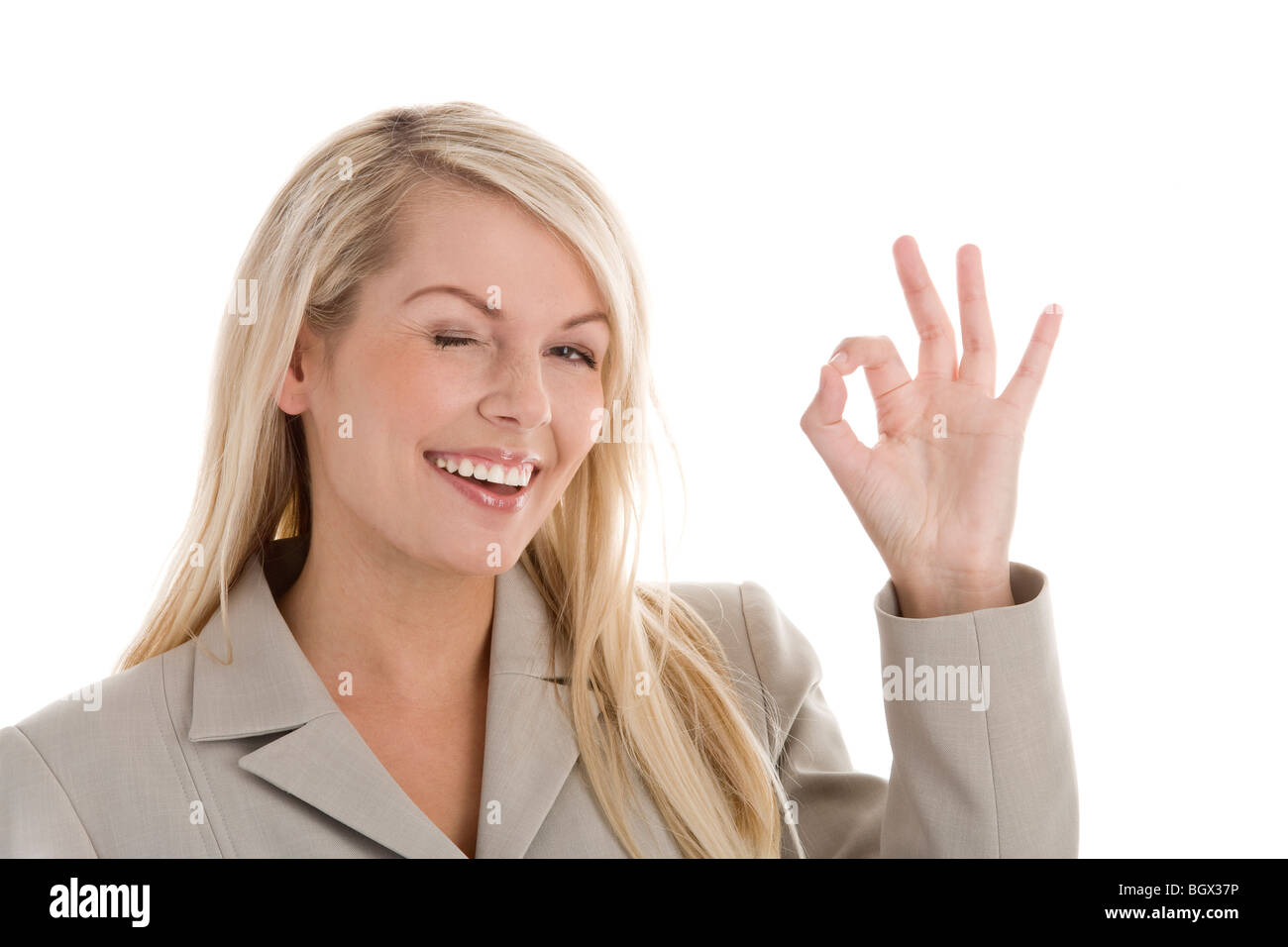 Portrait of attractive businesswoman indicating OK sign winking ...