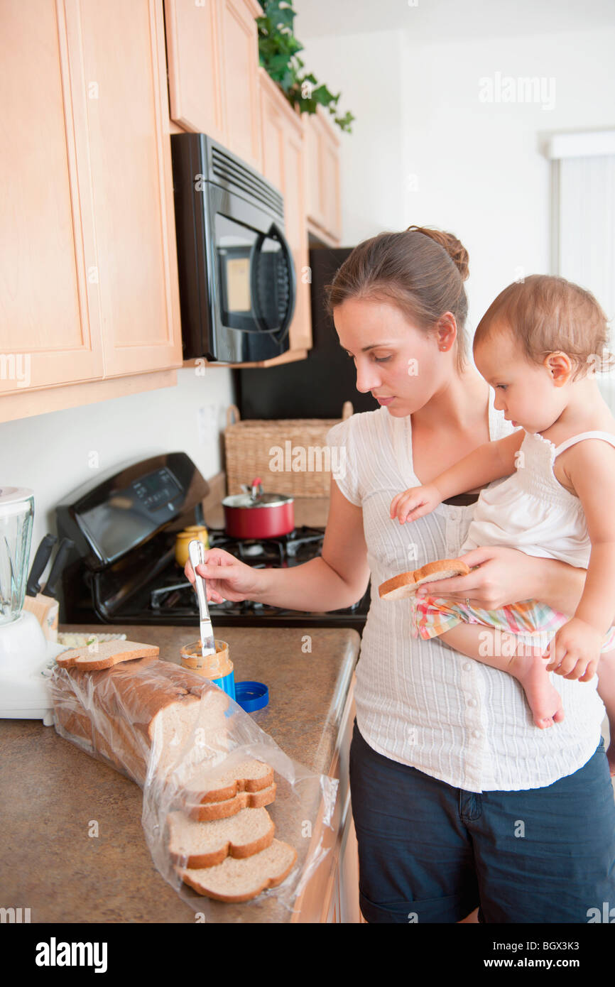 A mother making a sandwich for his baby girl Stock Photo - Alamy