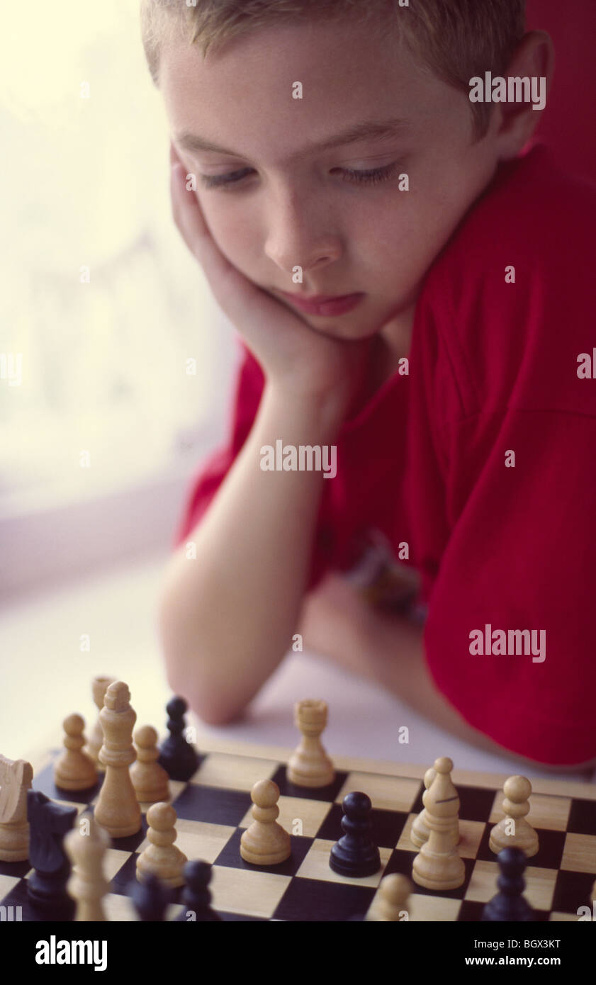 Boy playing chess Stock Photo - Alamy