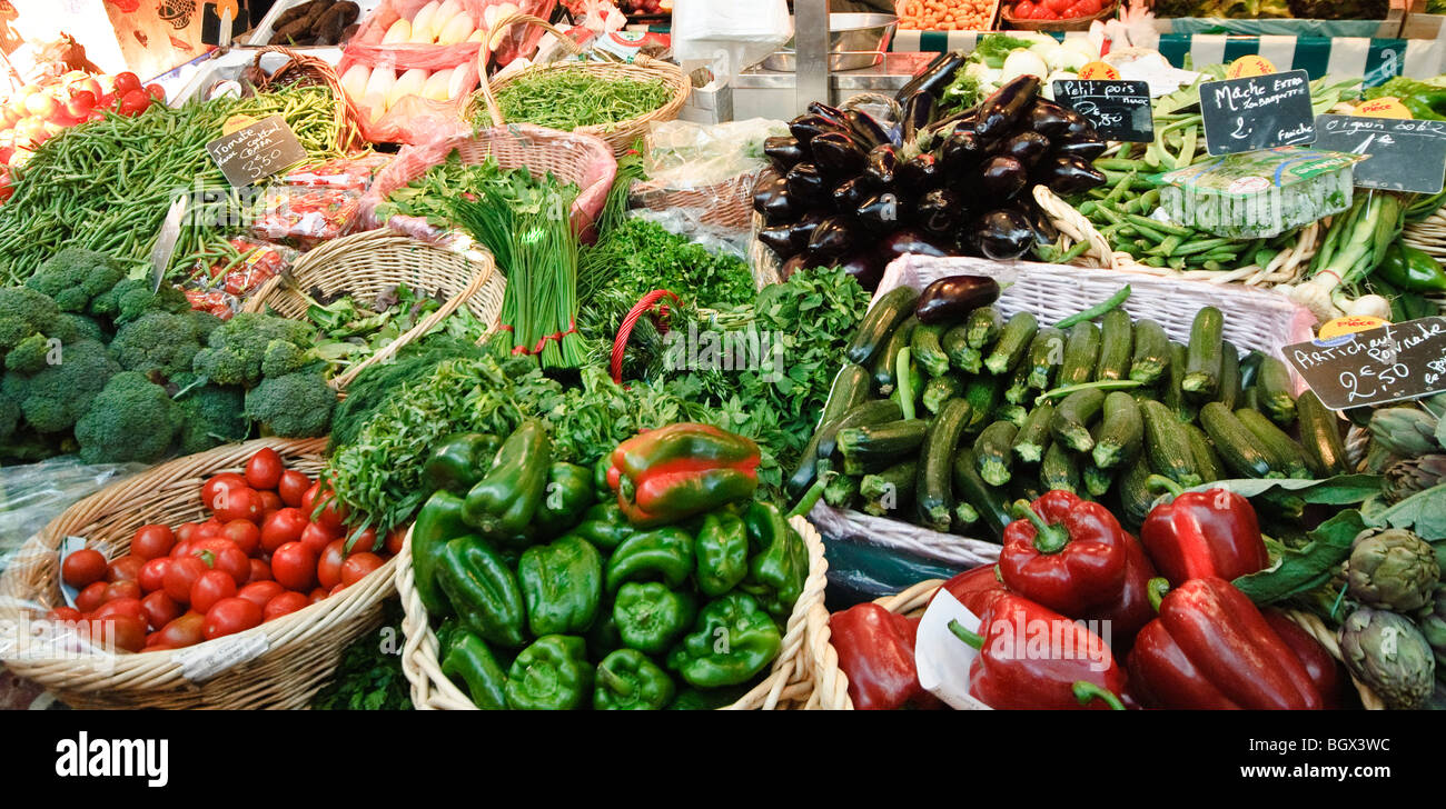 PARIS, France — A vibrant Parisian open-air market displays an array of ...