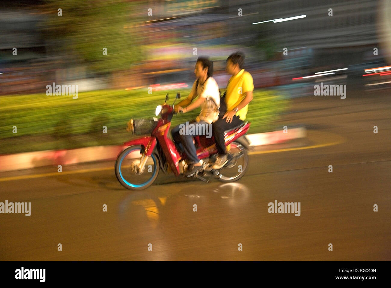 Two people riding a motorcycle Stock Photo - Alamy