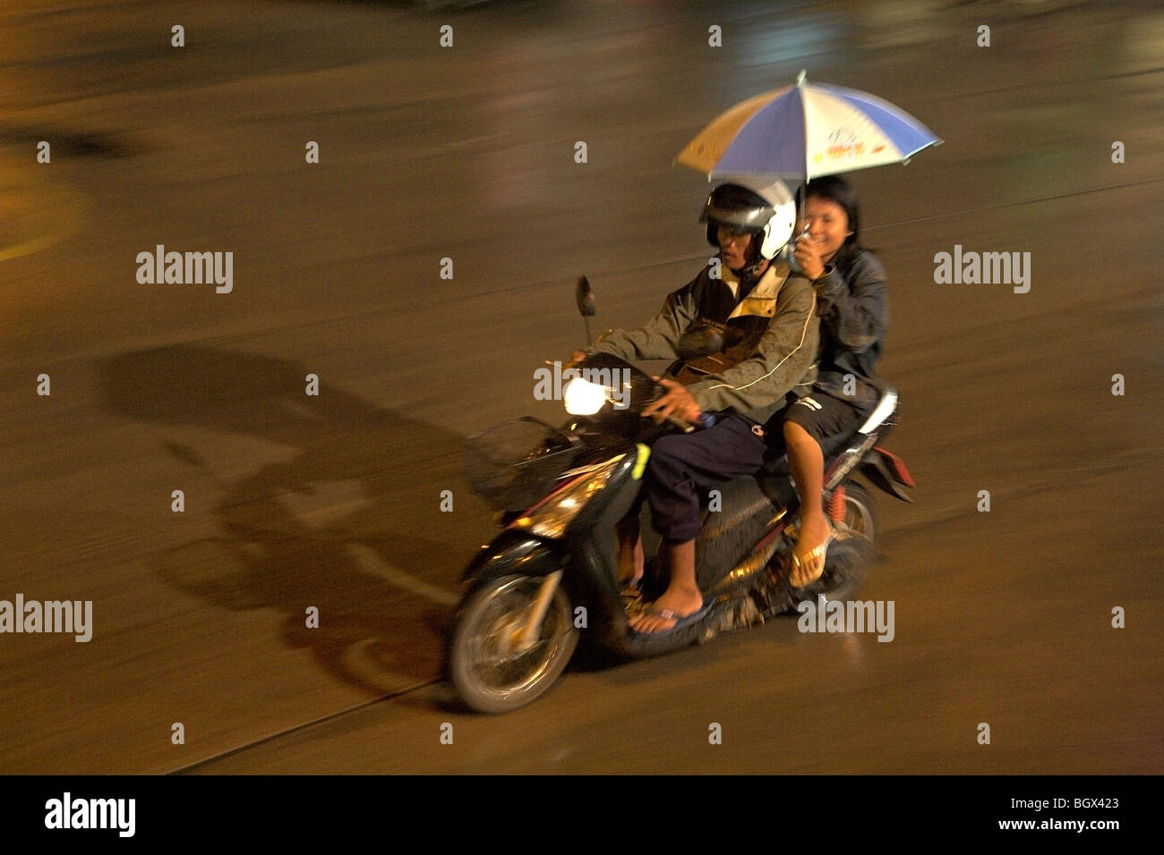 Two people riding a motorcycle Stock Photo - Alamy