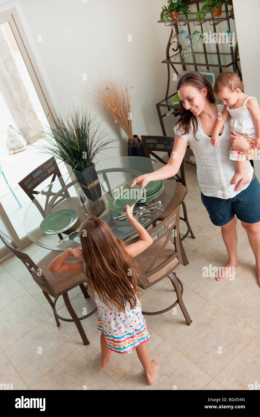 Setting the table together Stock Photo - Alamy