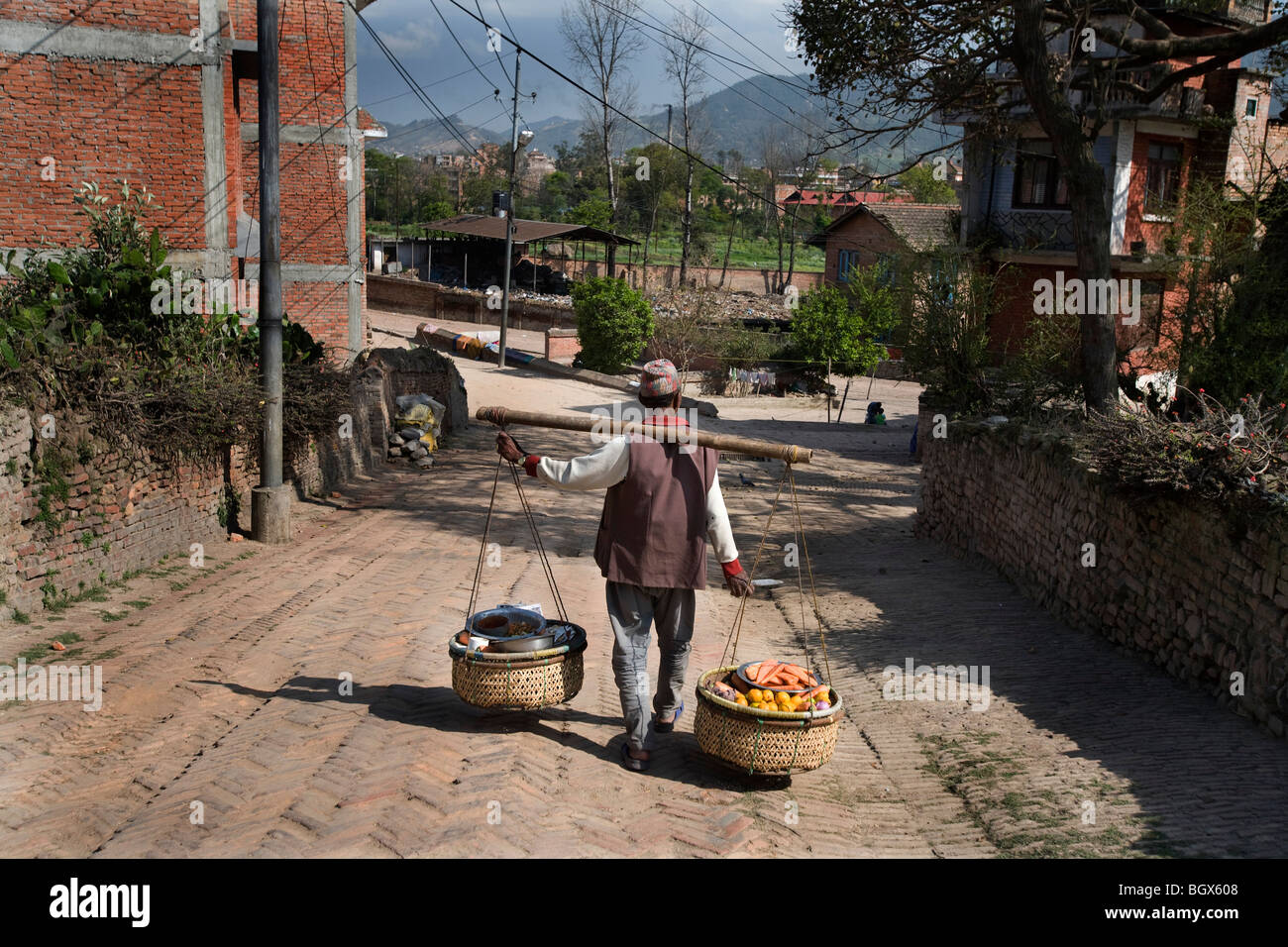 Man carrying baskets of food Stock Photo - Alamy