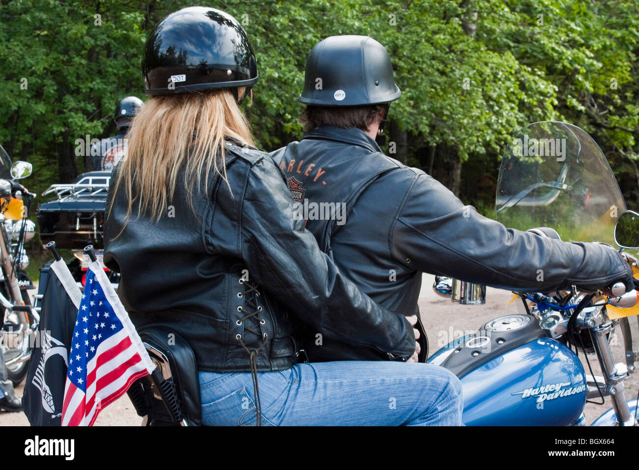 American couple motorbikers sitting on motorcycle Harley Davidson a ...