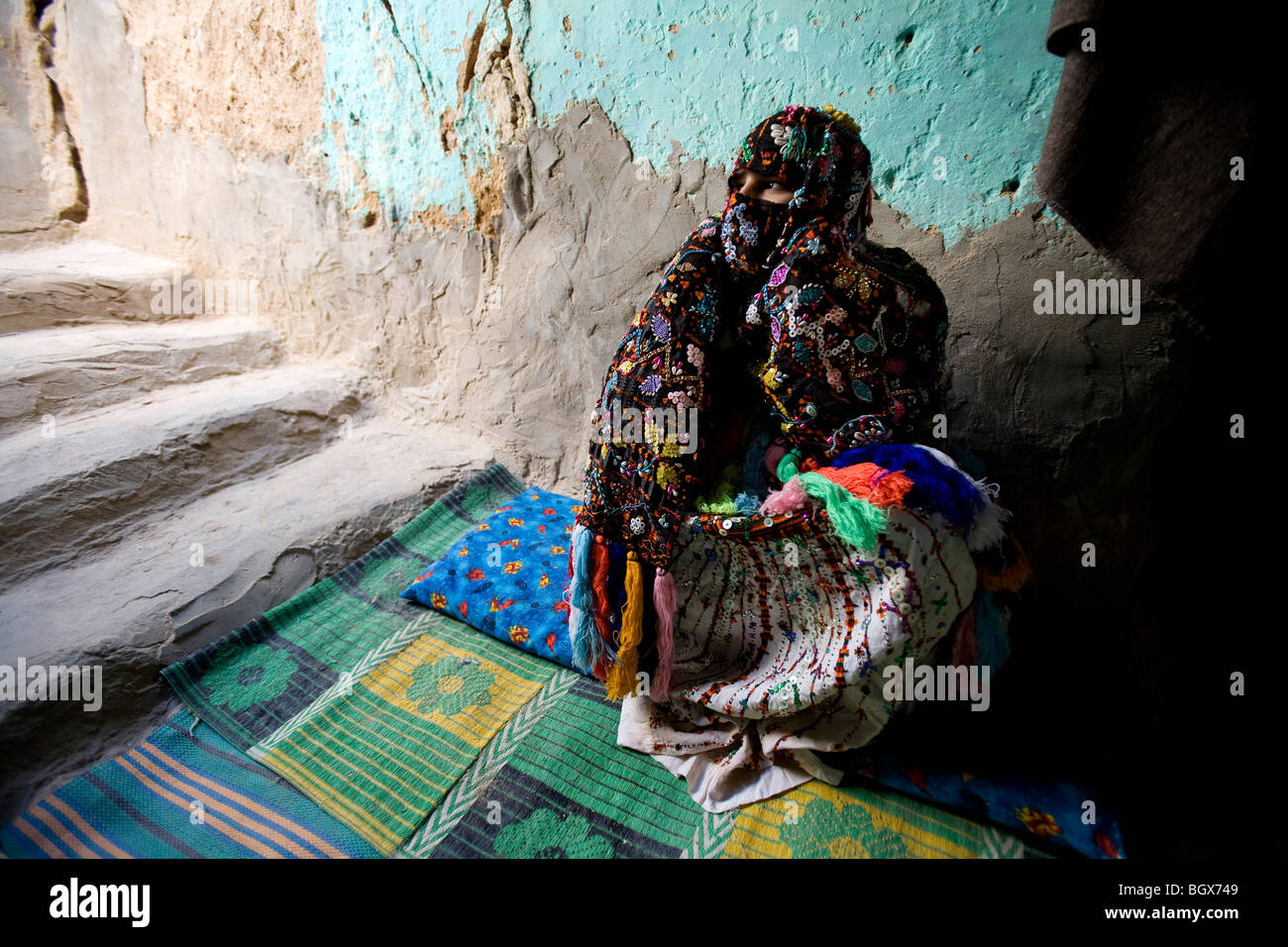 Woman crouching in Siwan house Stock Photo - Alamy