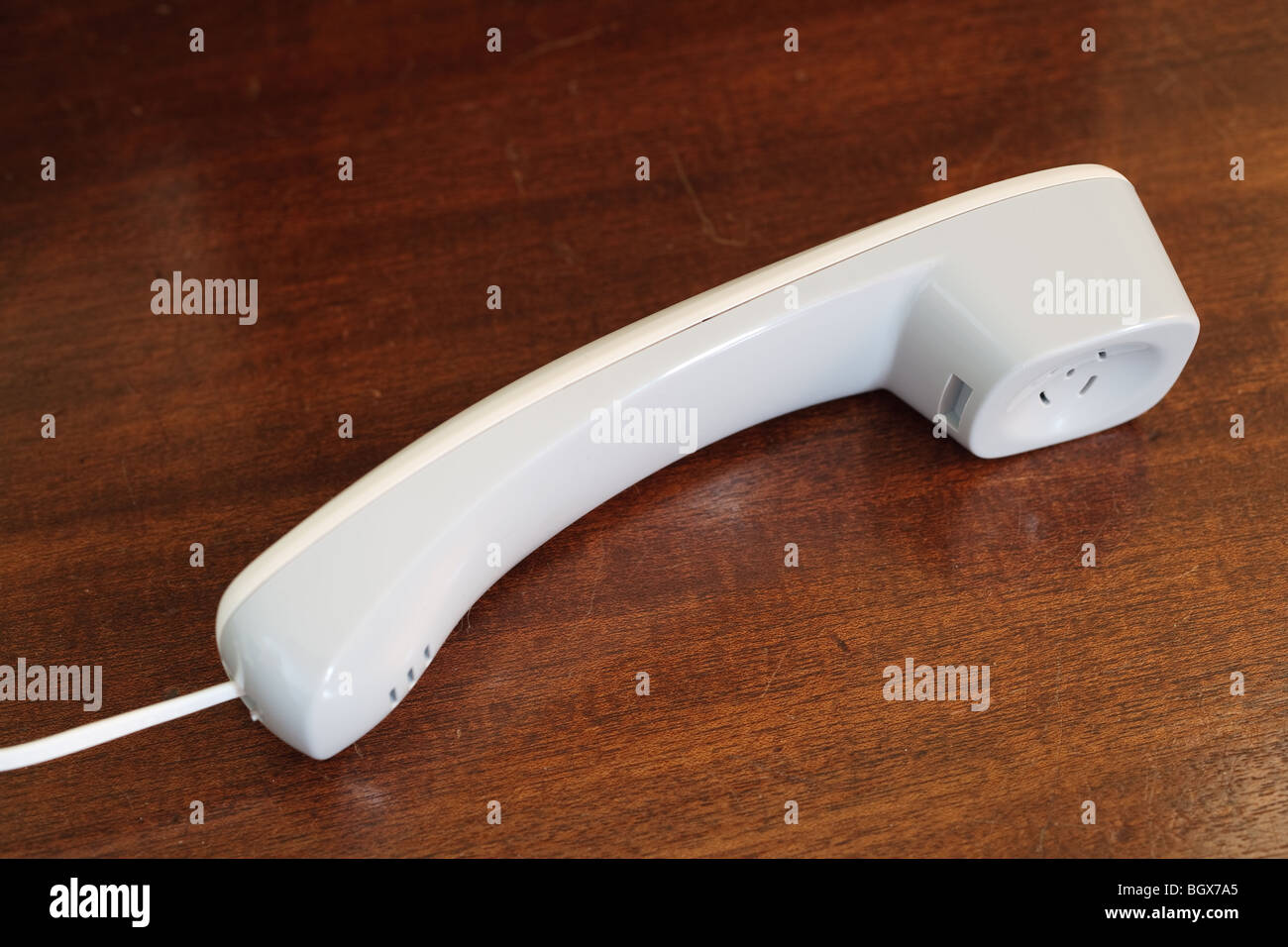 A telephone receiver on a desk Stock Photo - Alamy