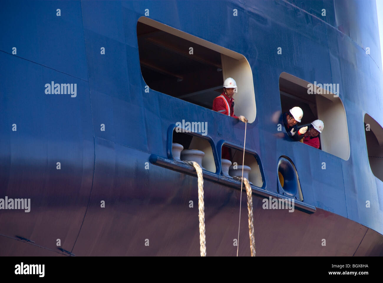 Crewmen on a car ship involved in mooring operations during arrival in ...
