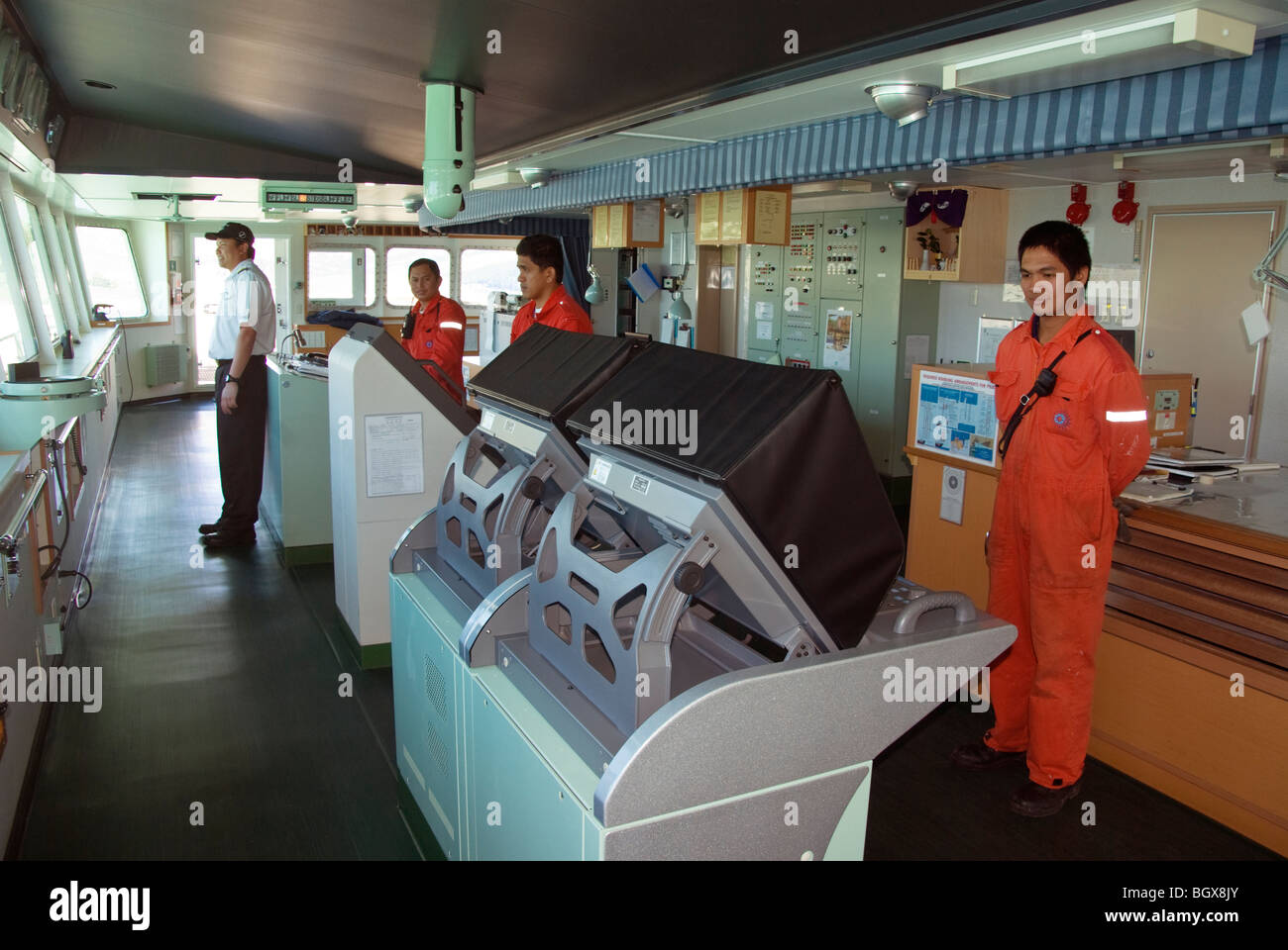 Captain and crew members on bridge of a ship entering port Stock Photo ...