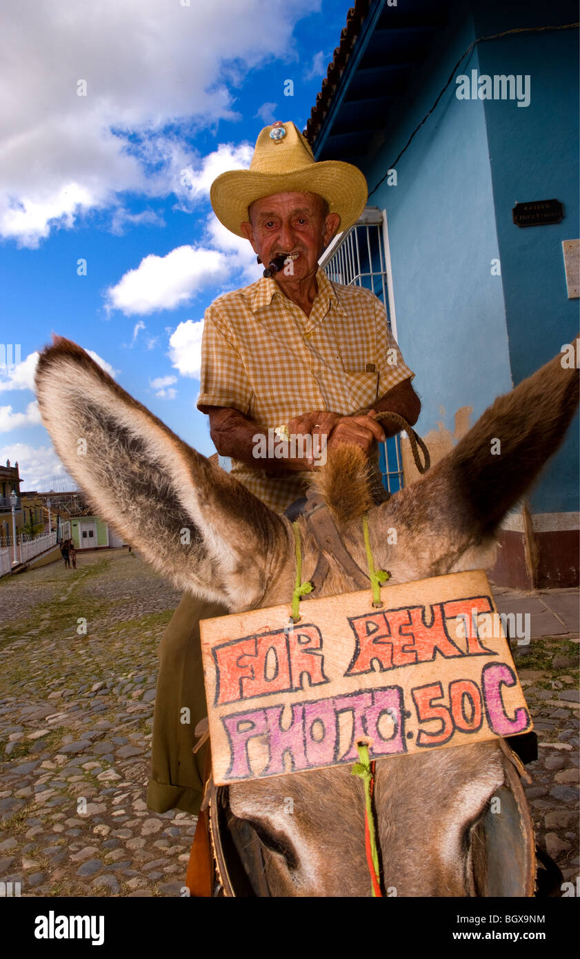 Old man with his donkey for rides on streets of old village of Trinidad ...
