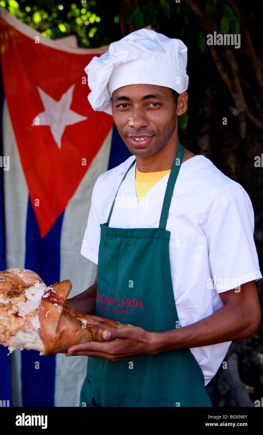 Chef cooking pig in square in Cienfuegos Cuba with Cuban flag Stock ...