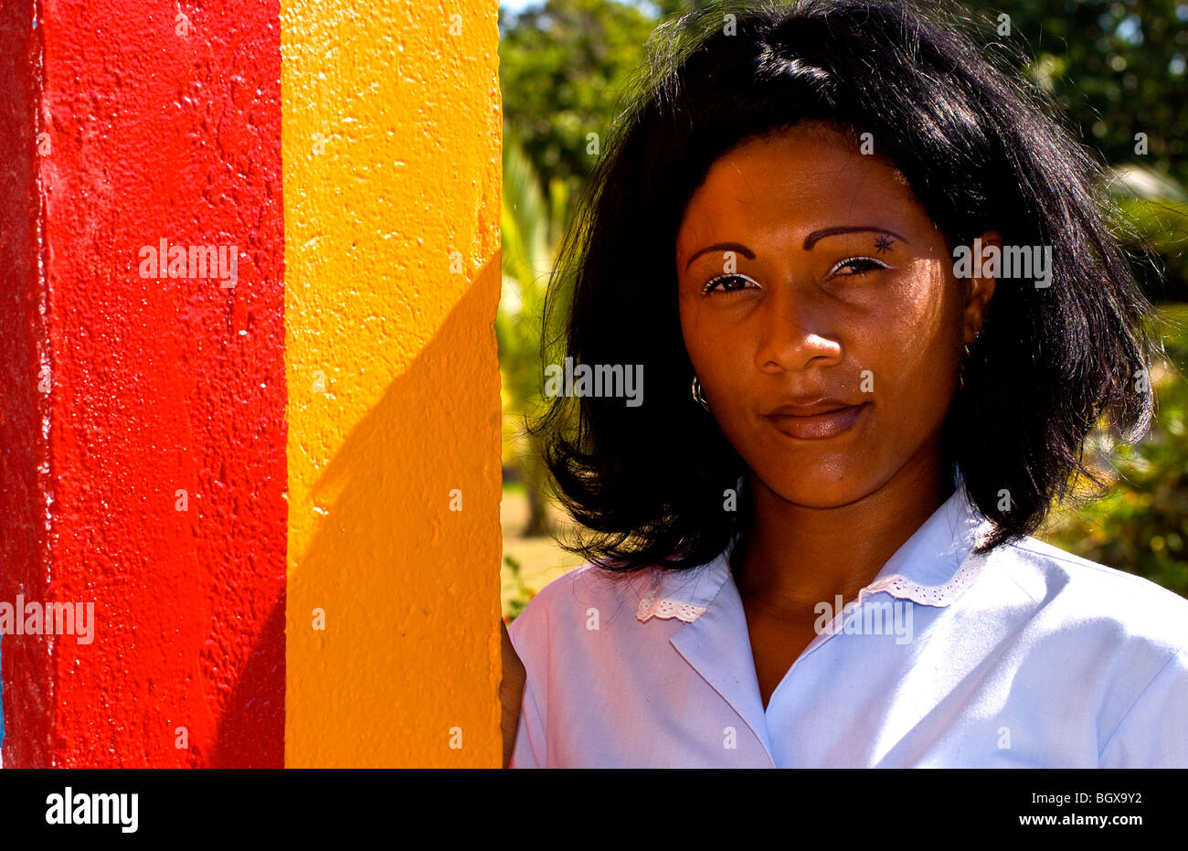 Beautiful local woman with star near eye on colorful wall in old ...