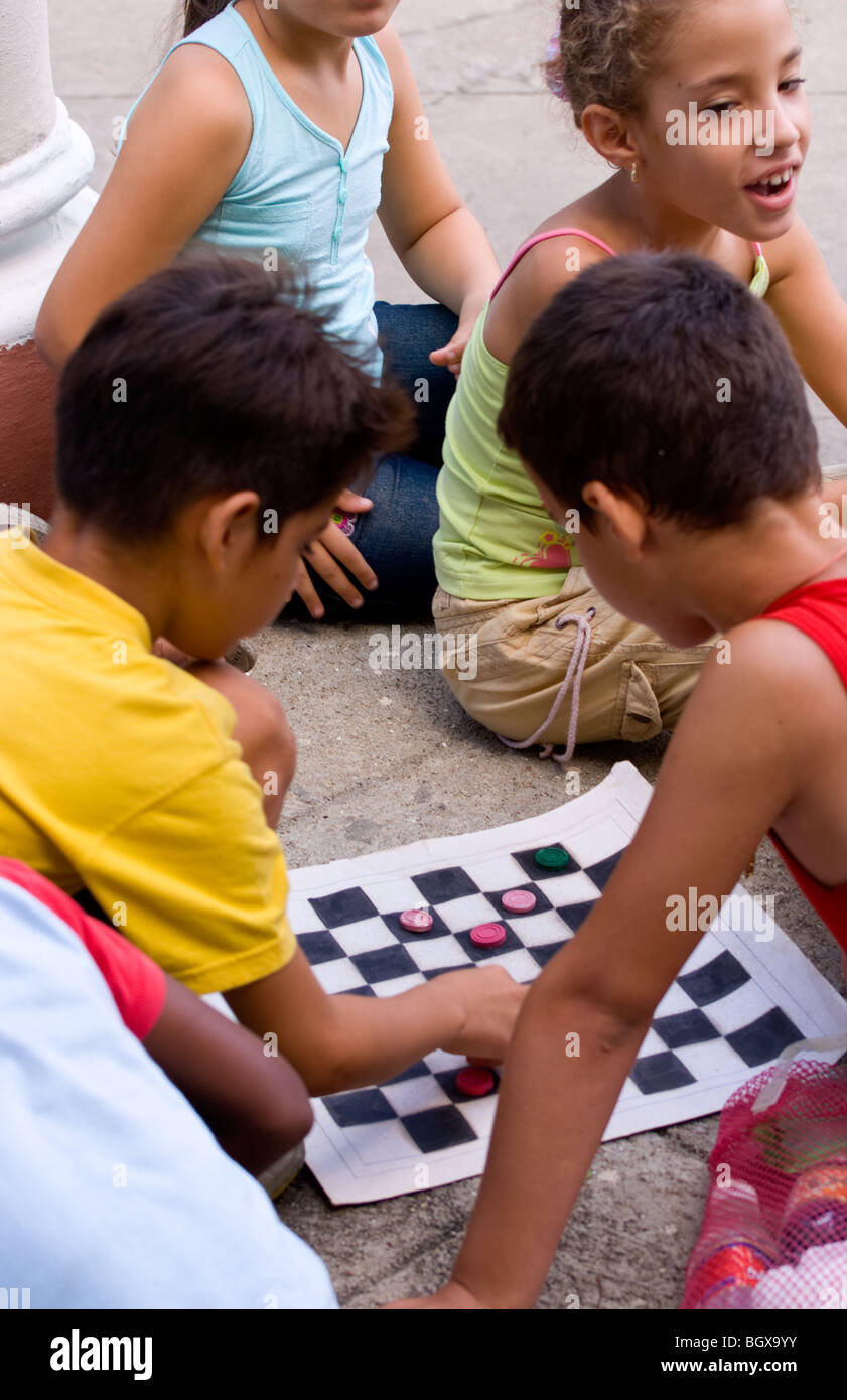 Children playing checkers in park in square in Cienfuegos Cuba Stock ...
