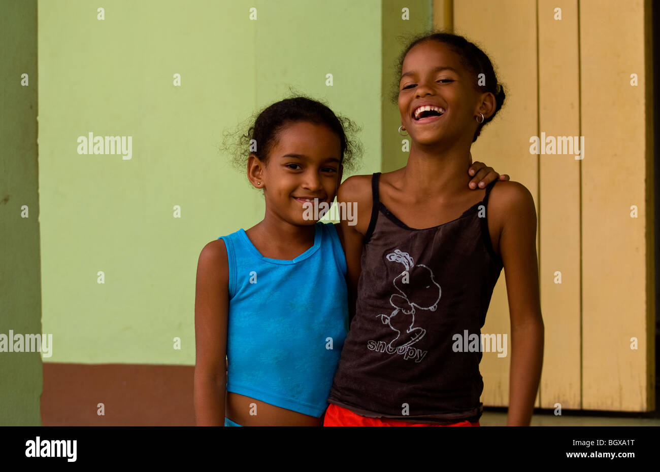 Young local girls in front of their home in old colonial village of ...