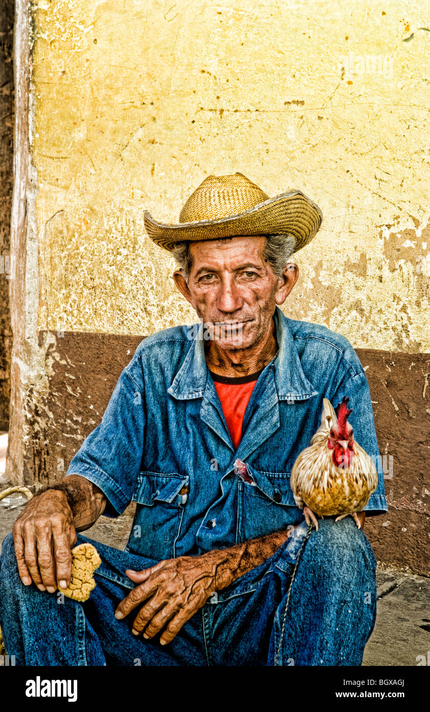 Old man with his chicken on streets of old village of Trinidad Cuba ...