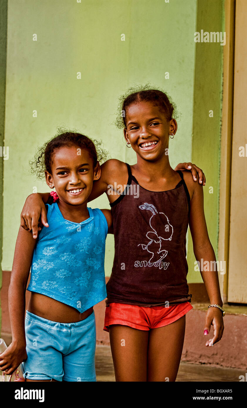 Young local girls in front of their home in old colonial village of ...
