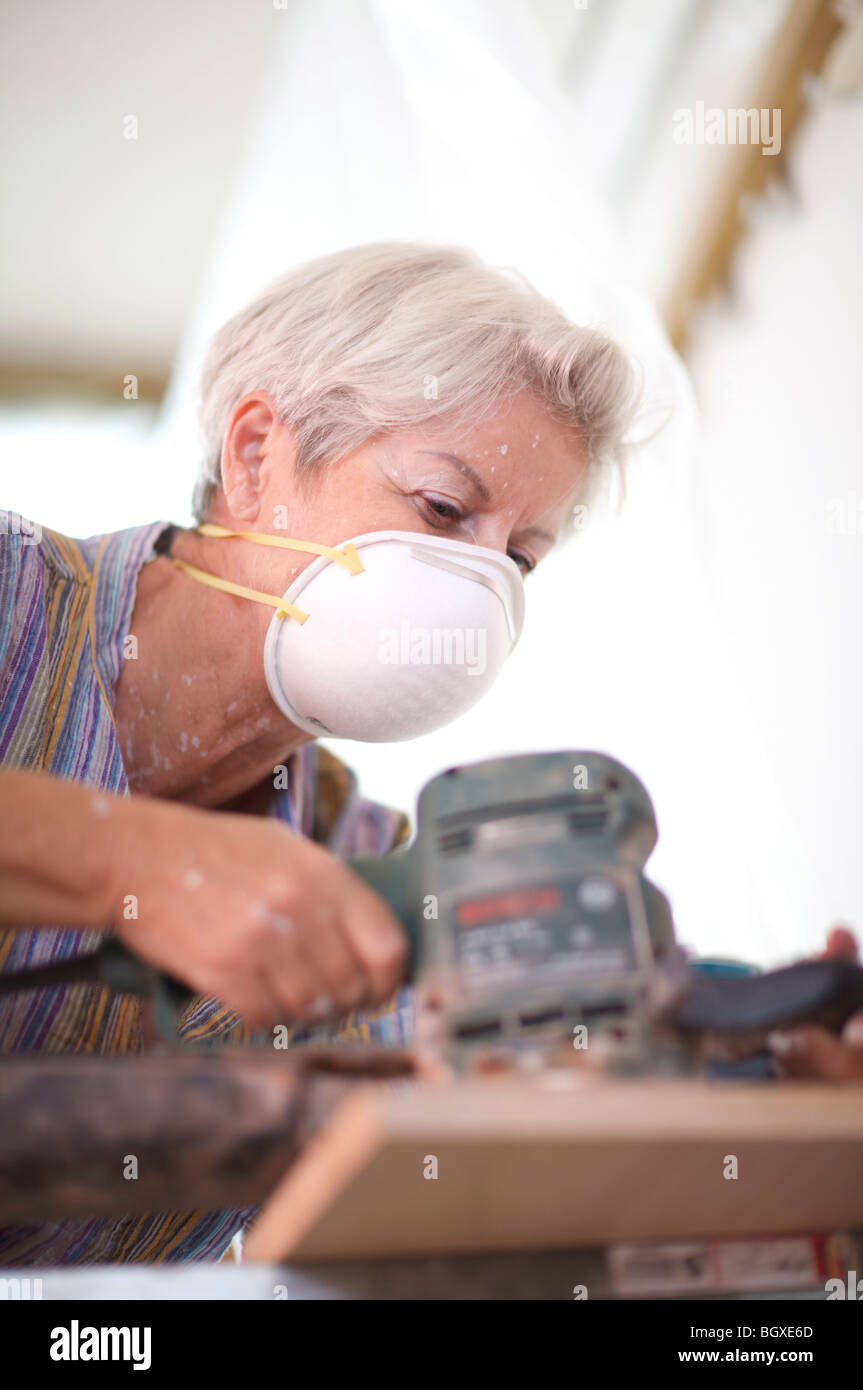 Mature woman doing DIY Stock Photo - Alamy
