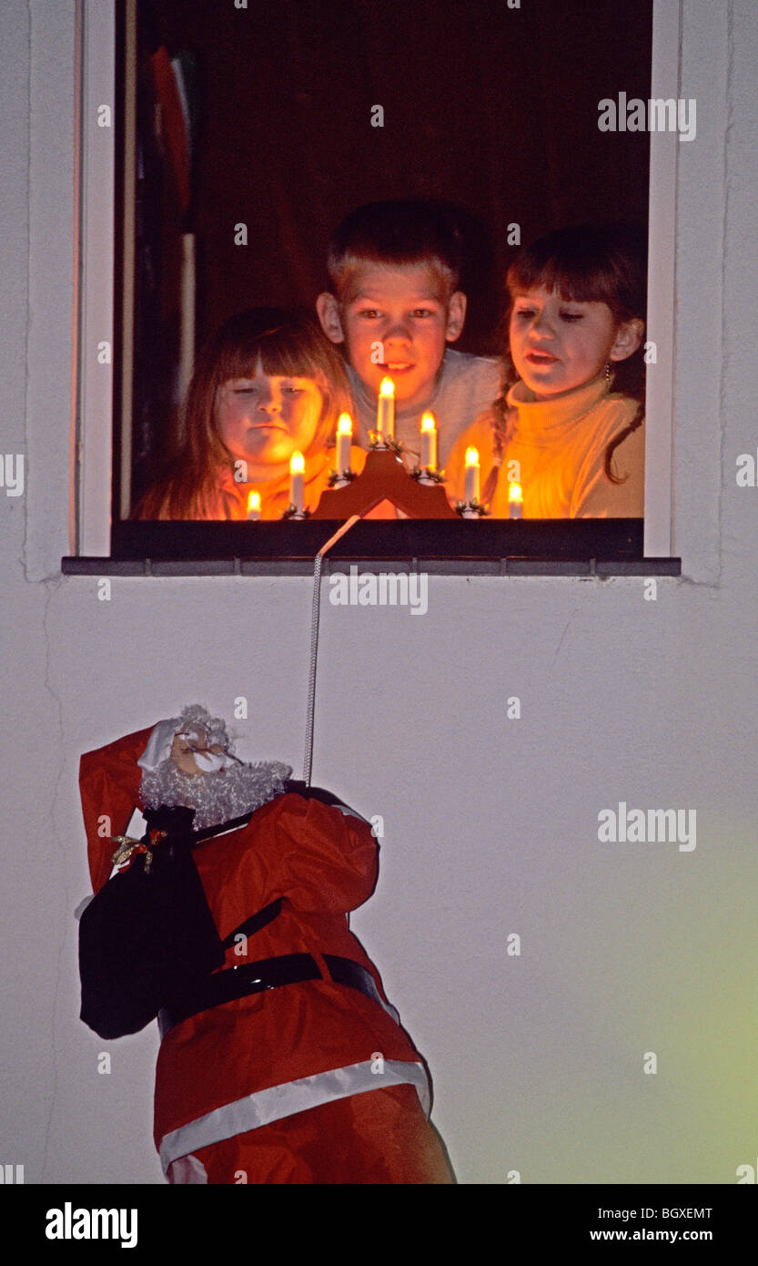 young kids watching Santa Claus climb into their house Stock Photo - Alamy