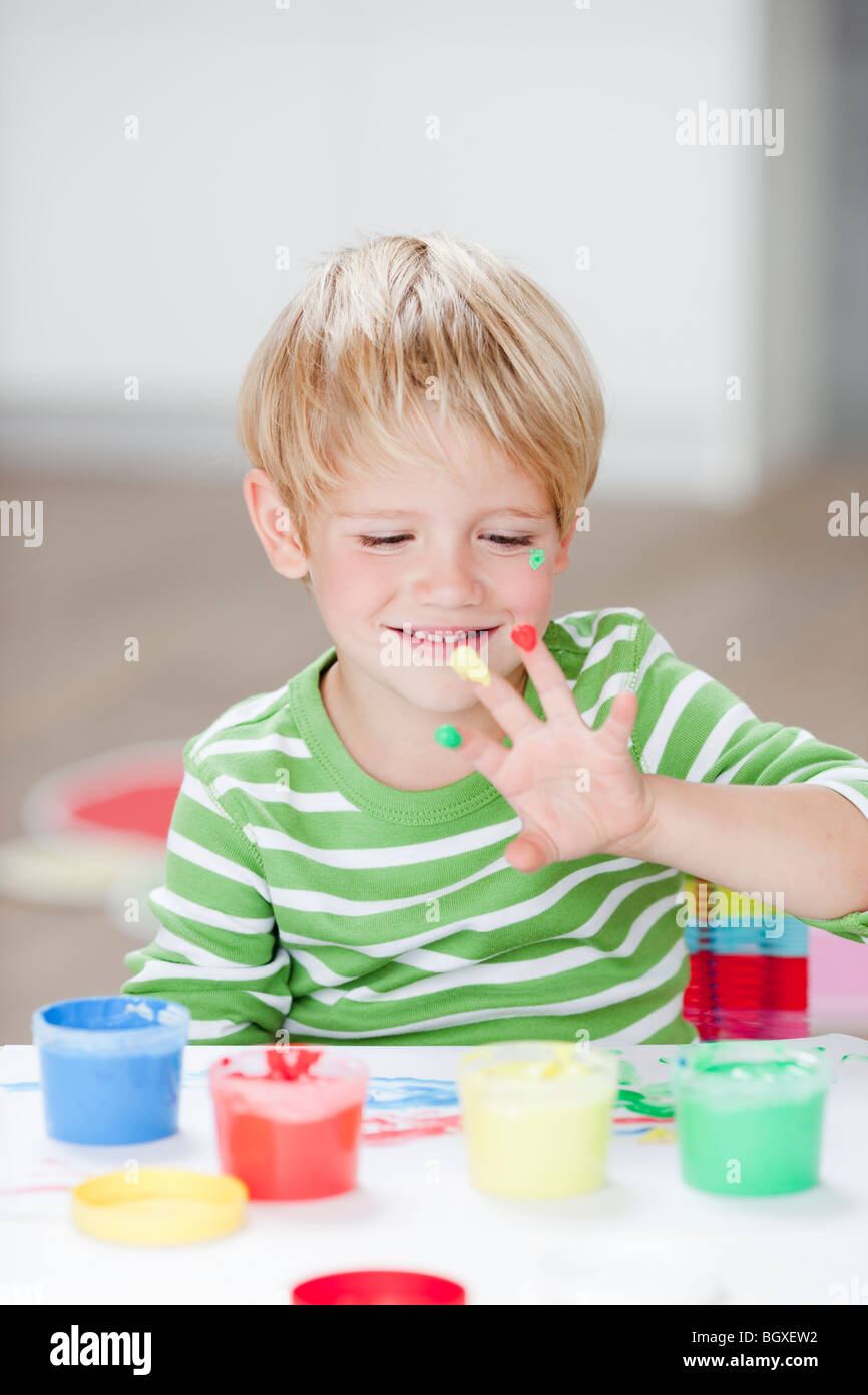 young boy playing with colours Stock Photo - Alamy