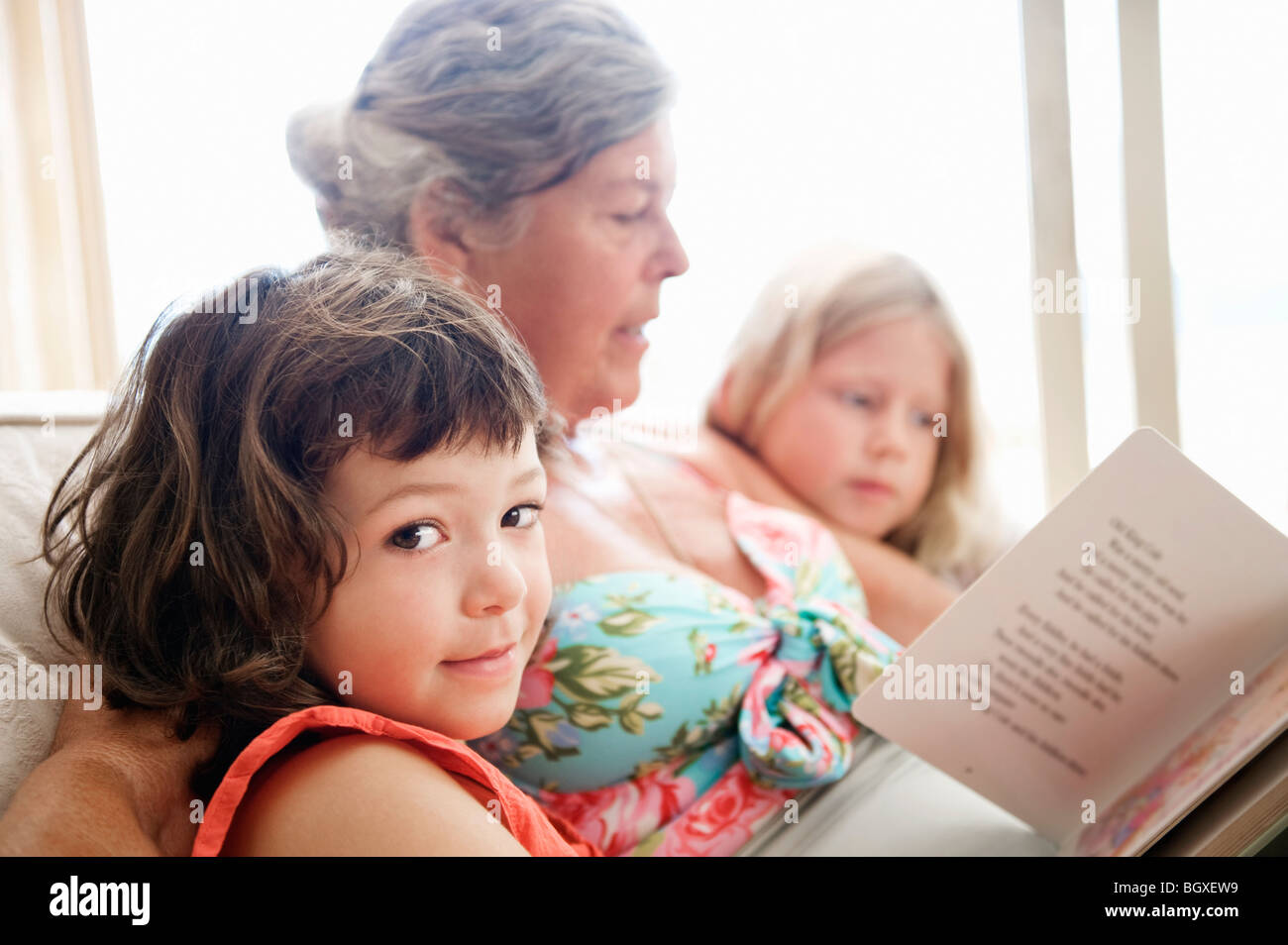 A senior female reading to some children Stock Photo - Alamy