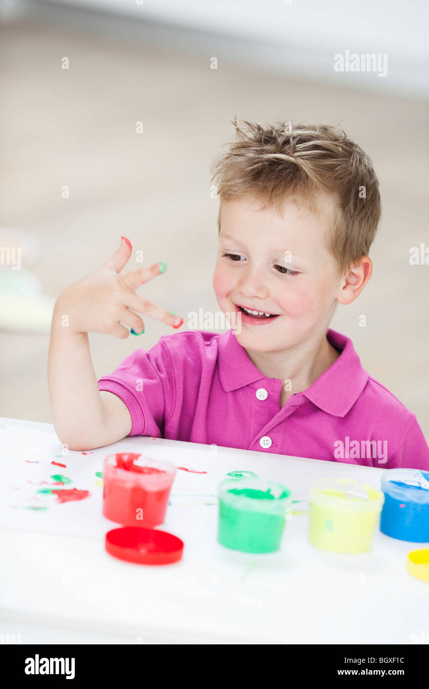 young boy playing with colours Stock Photo - Alamy