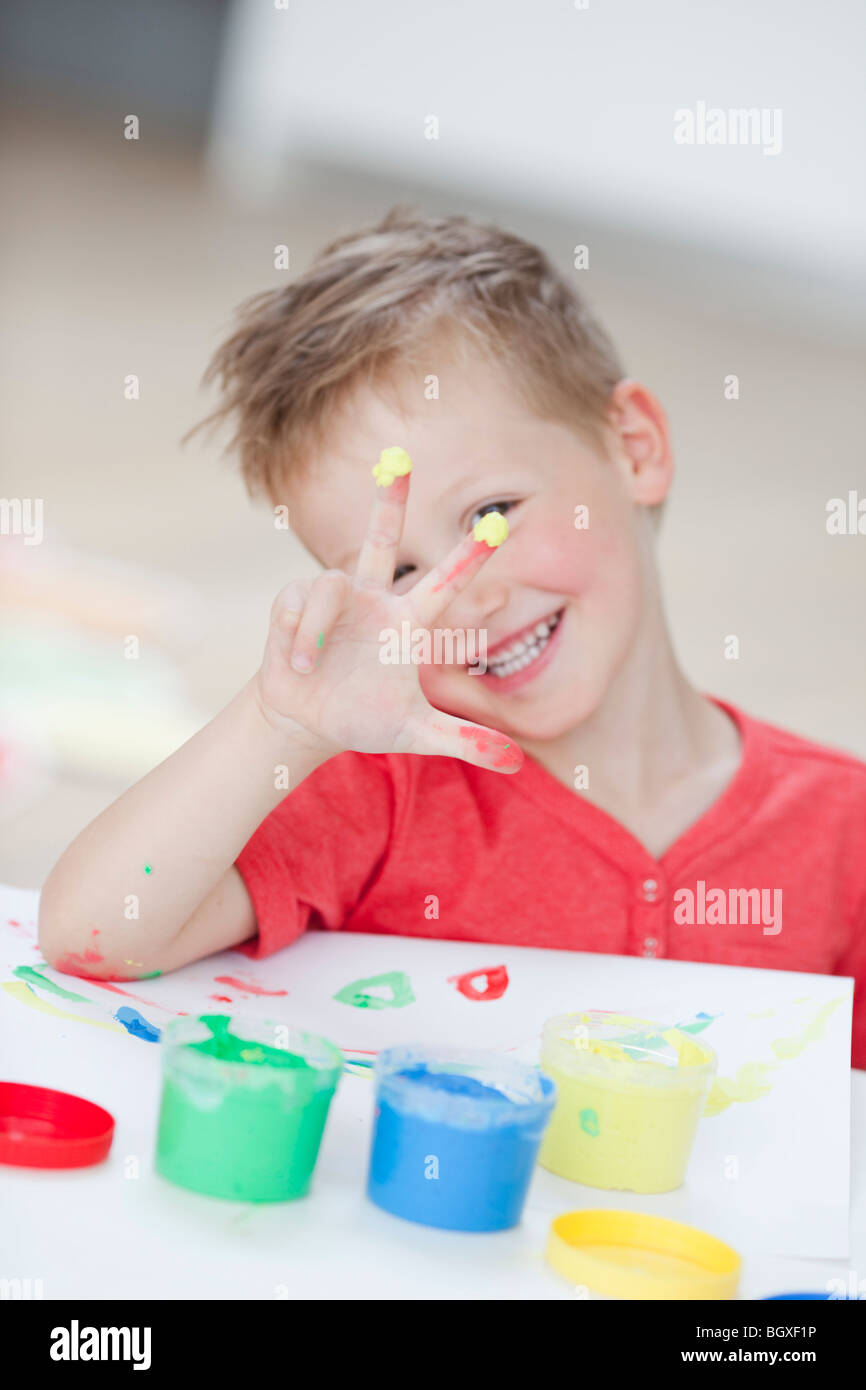 young boy playing with colours Stock Photo - Alamy