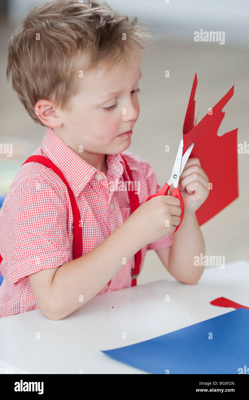 young boy with paper and scissors Stock Photo - Alamy