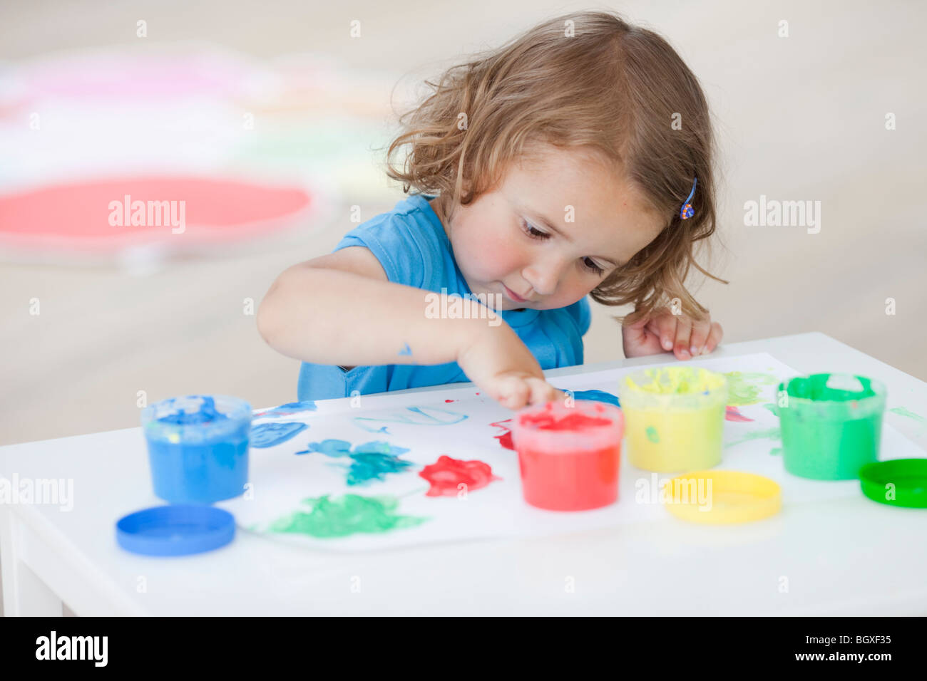 young girl playing with colours Stock Photo - Alamy