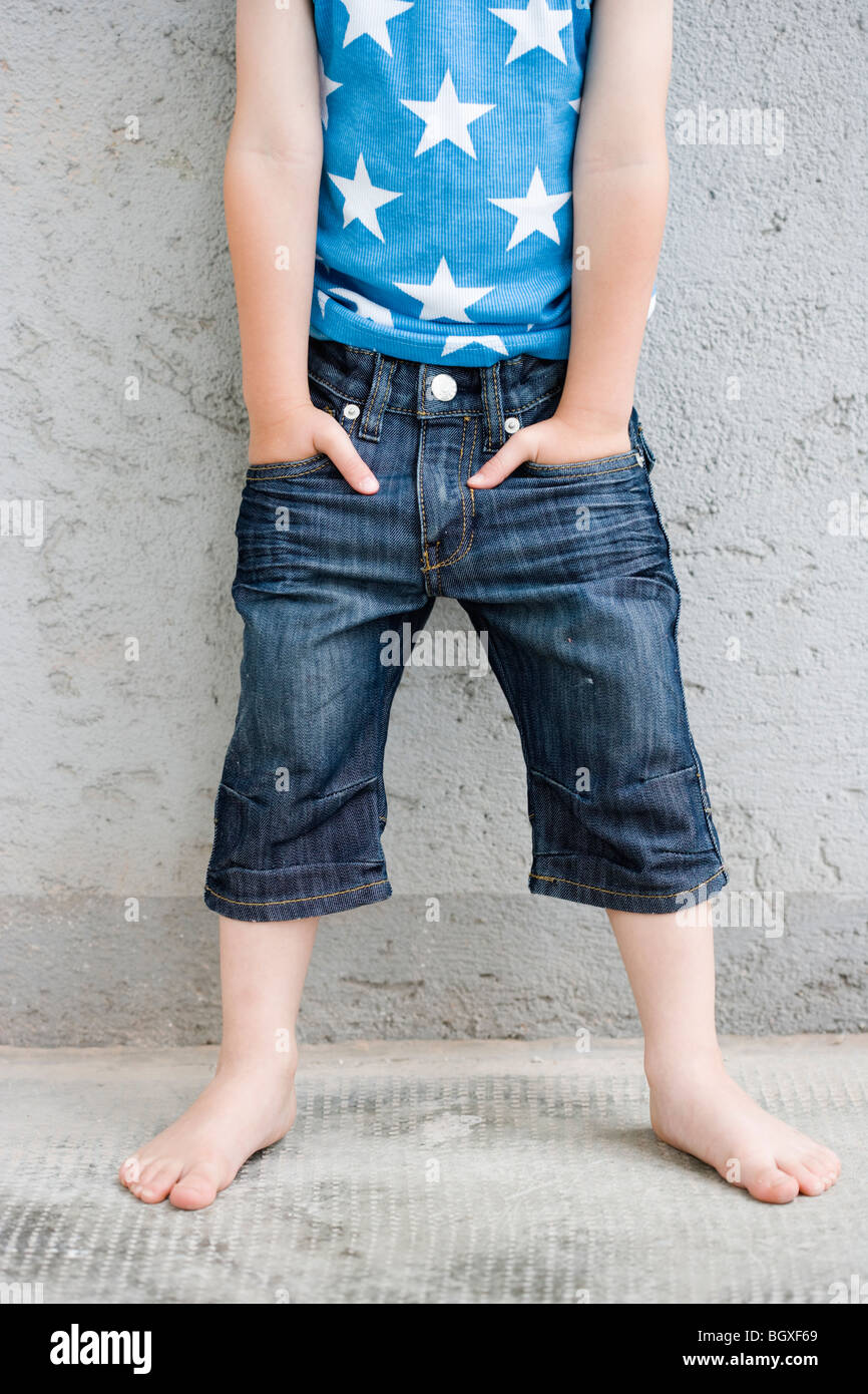 young boy standing at wall Stock Photo - Alamy