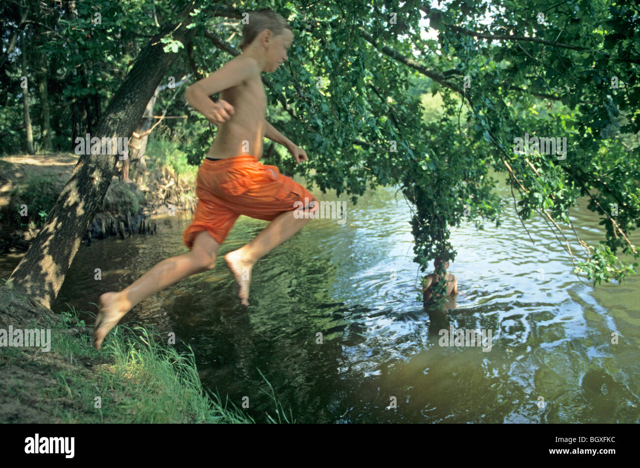 young boy jumping into a river Stock Photo - Alamy