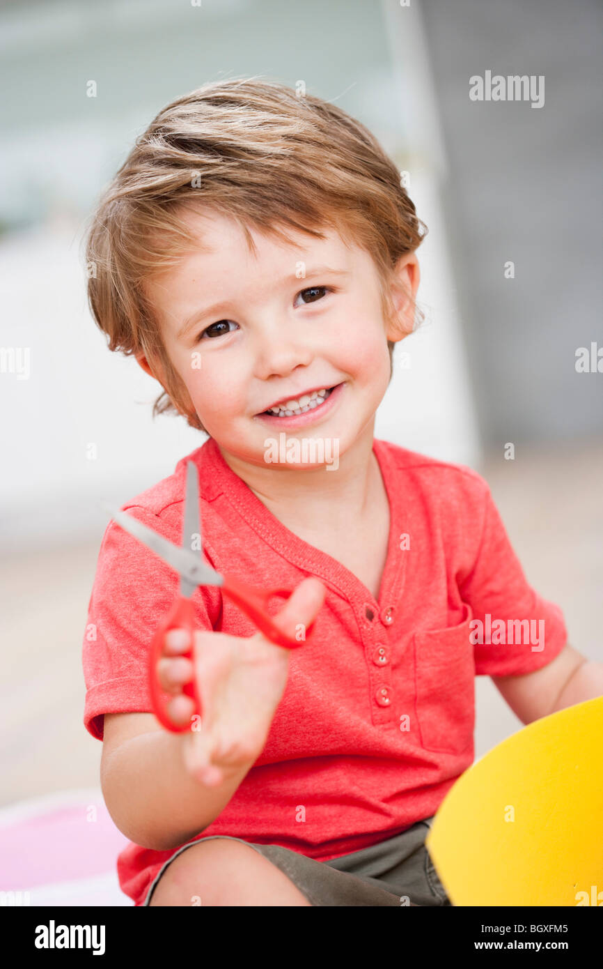 young boy playing with scissors Stock Photo - Alamy