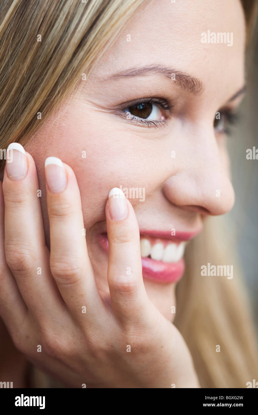 Young woman resting head on hand Stock Photo - Alamy