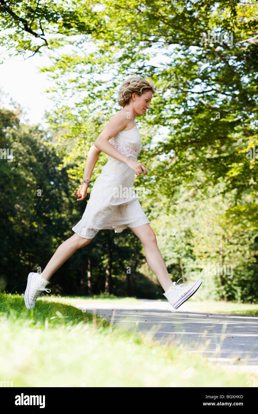 Lady running down the street hi-res stock photography and images - Alamy