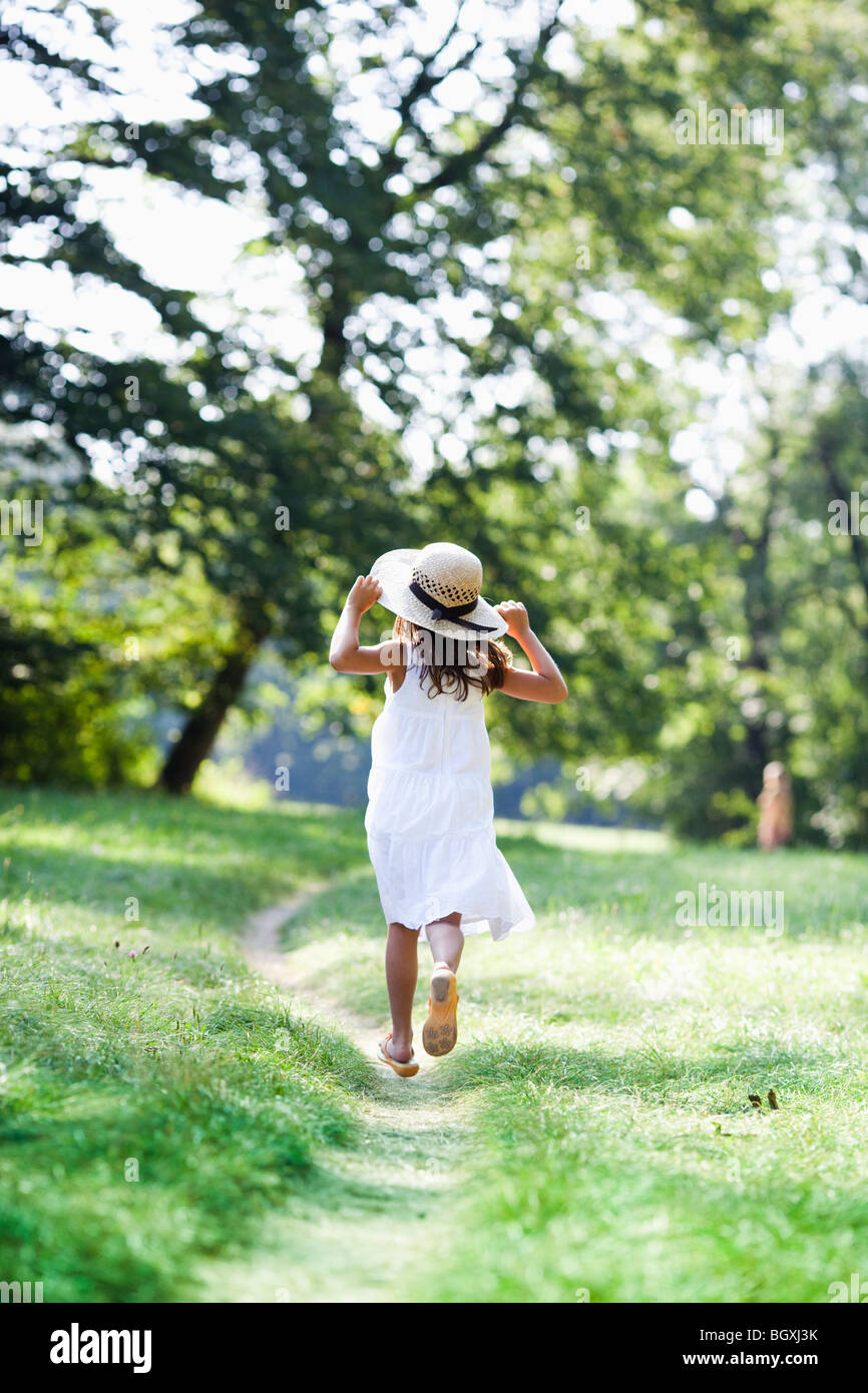 girl running down a path Stock Photo - Alamy