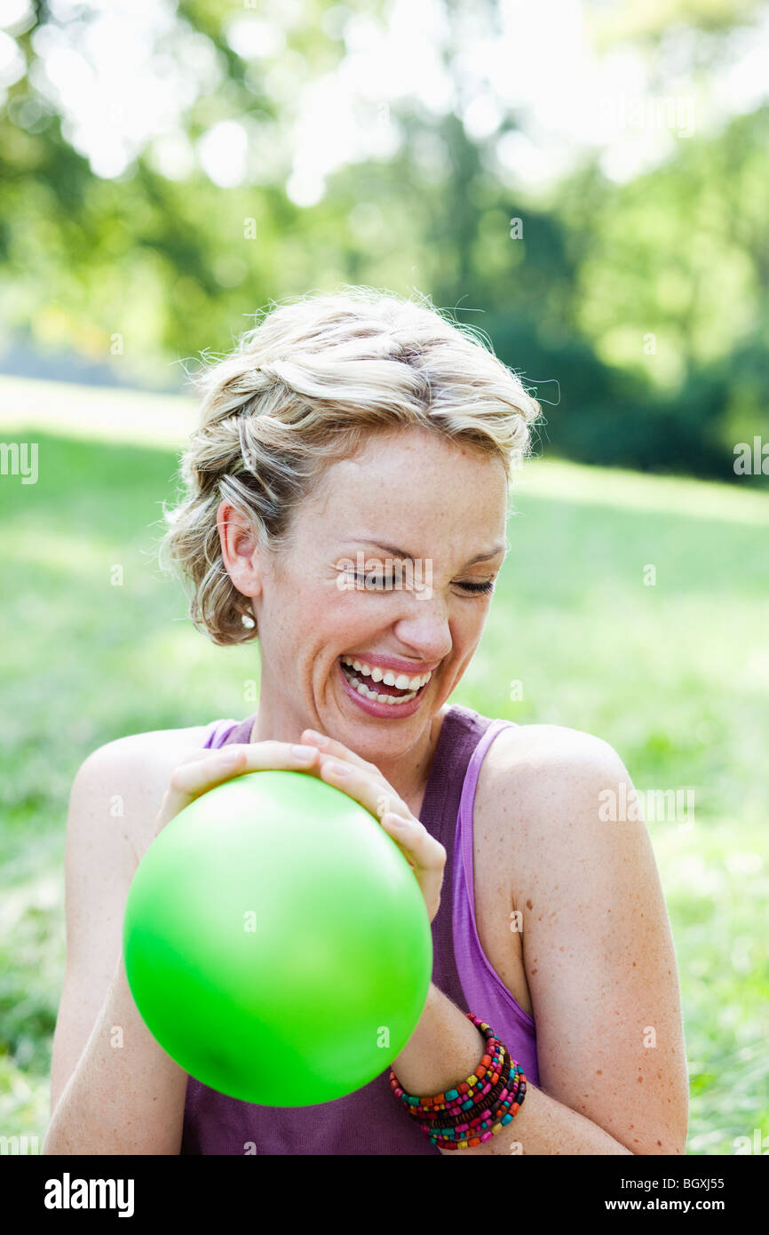 woman playing with balloon laughing Stock Photo - Alamy