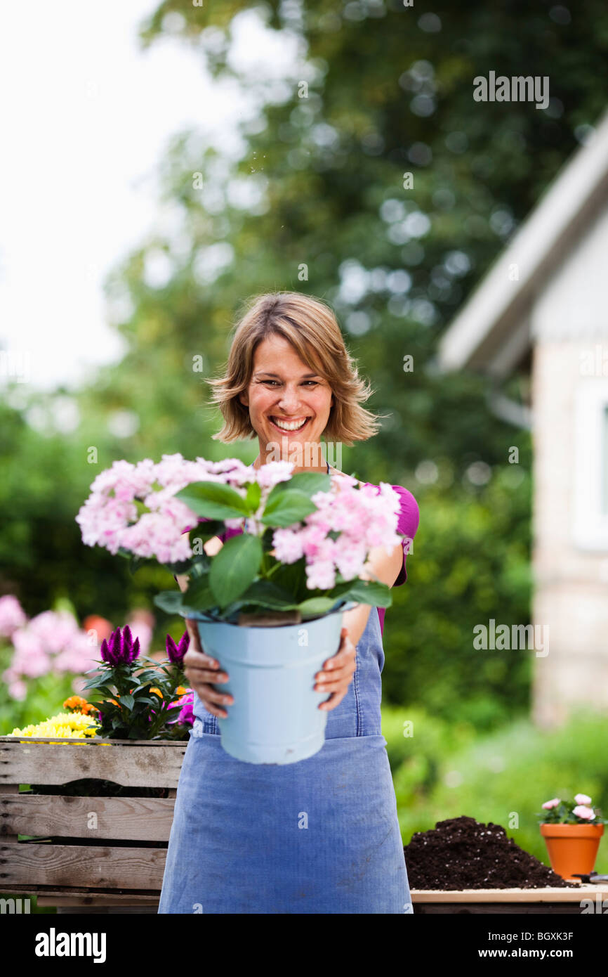 Woman spring flowers outside looking at camera hi-res stock photography ...