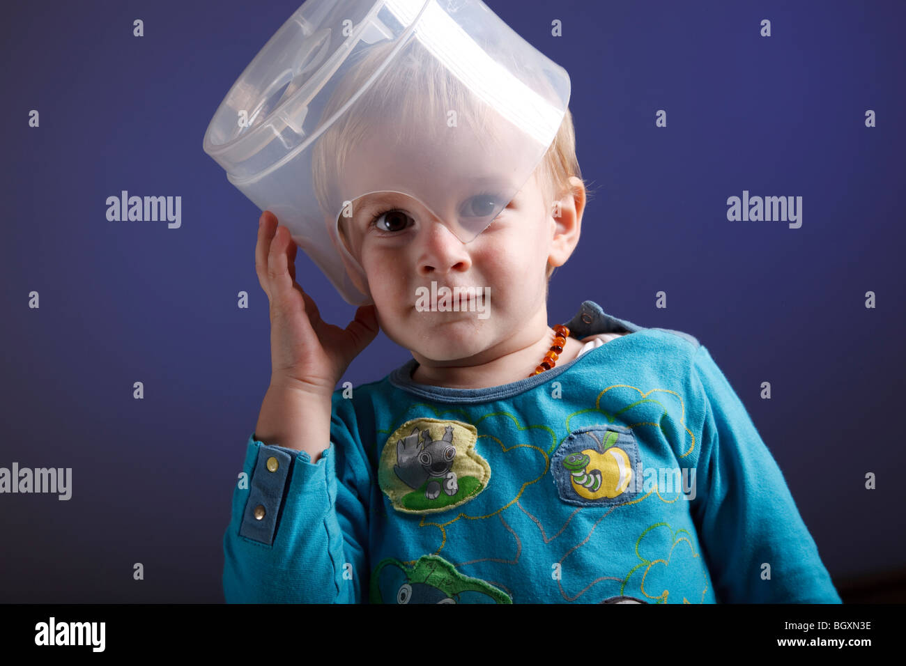 boy playing with plastic bucket Stock Photo - Alamy