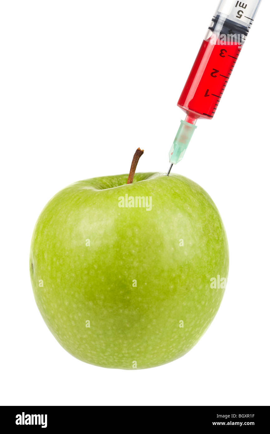A green apple being injected with a syringe containing red fluid ...