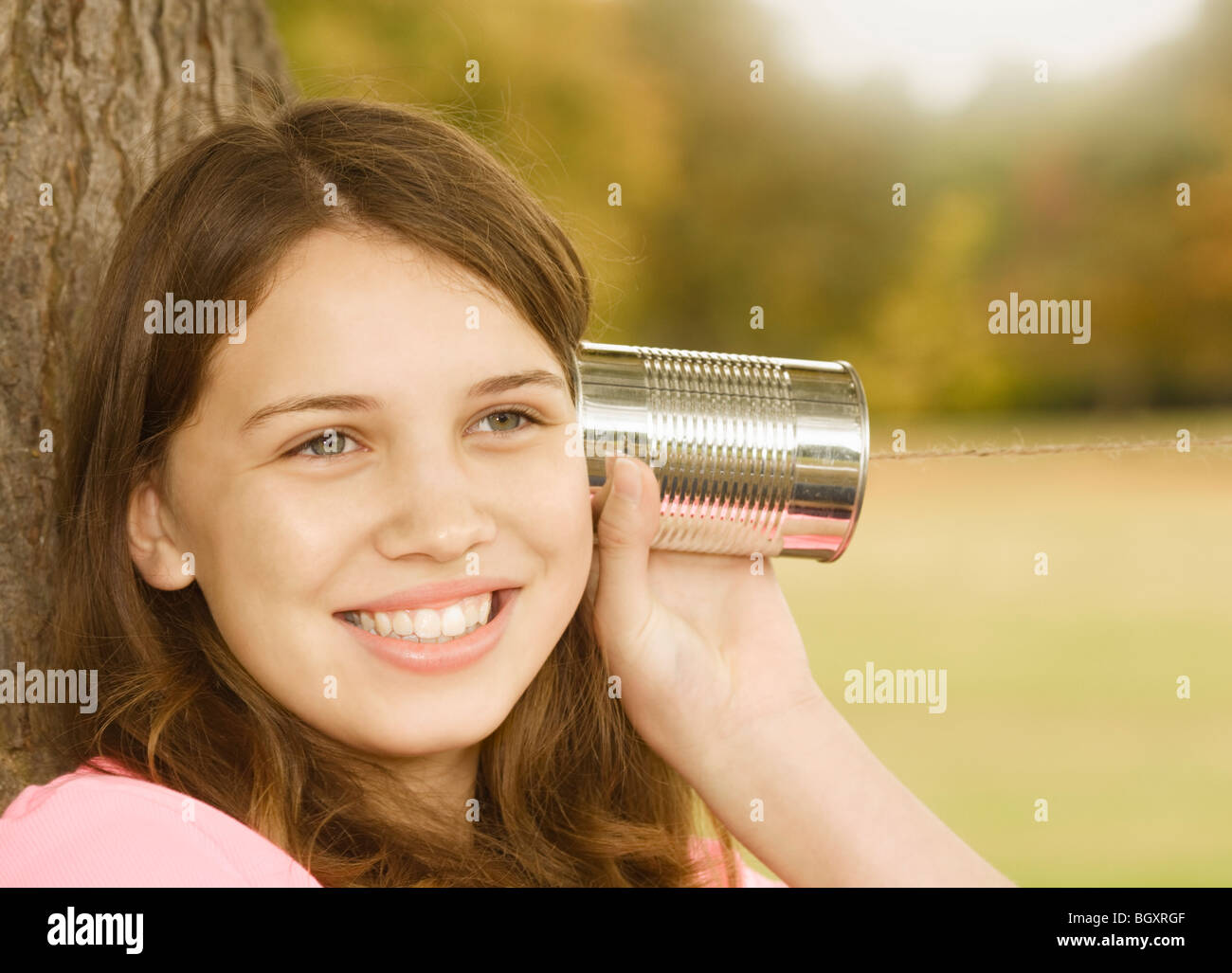 Girl Listening to Tin Can Phone Stock Photo - Alamy