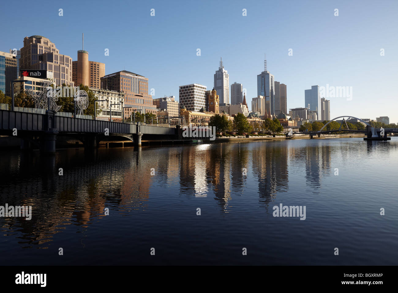 Early morning reflections of the city skyline and Sandridge Bridge in ...