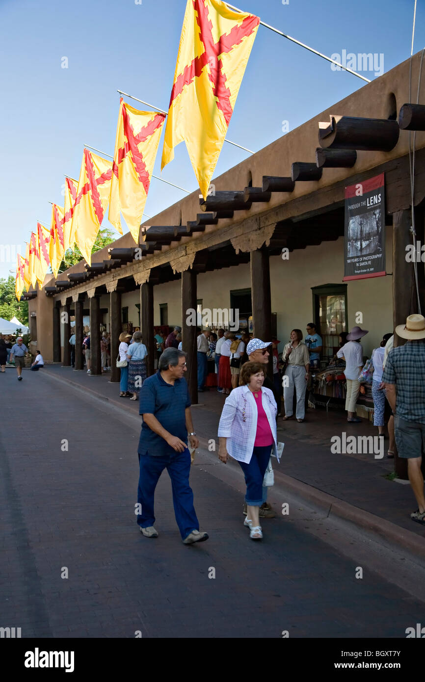 Tourists broswe the booths near the Palace of the Governors at the ...