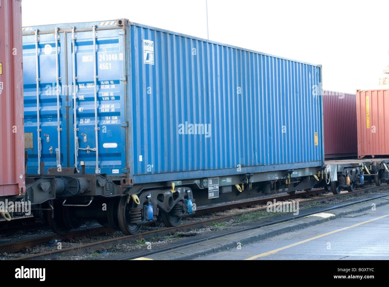 shipping container on rail carriage bogie at depot Stock Photo - Alamy