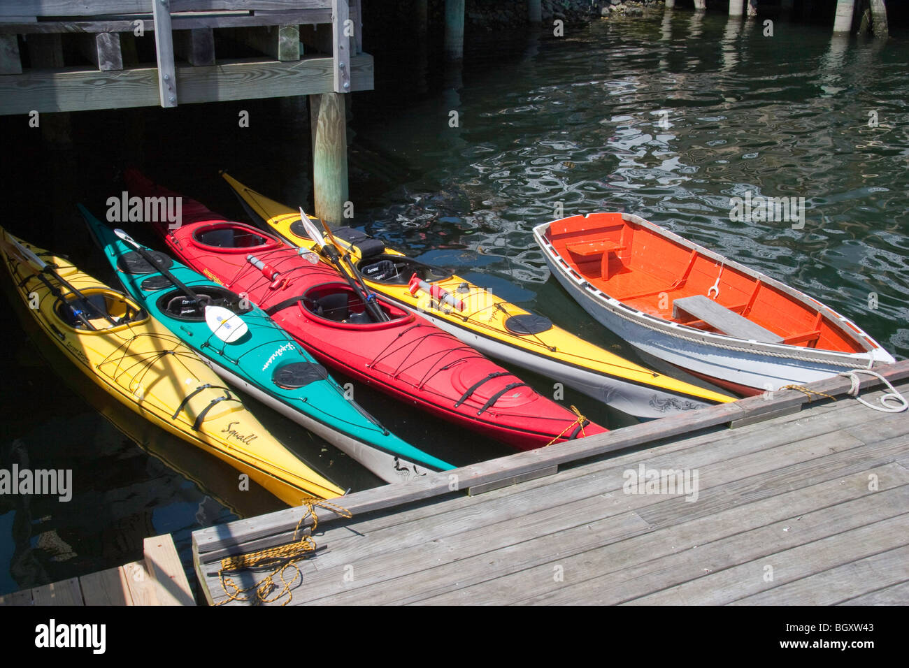 Colorful Kayaks and a Row Boat Stock Photo - Alamy