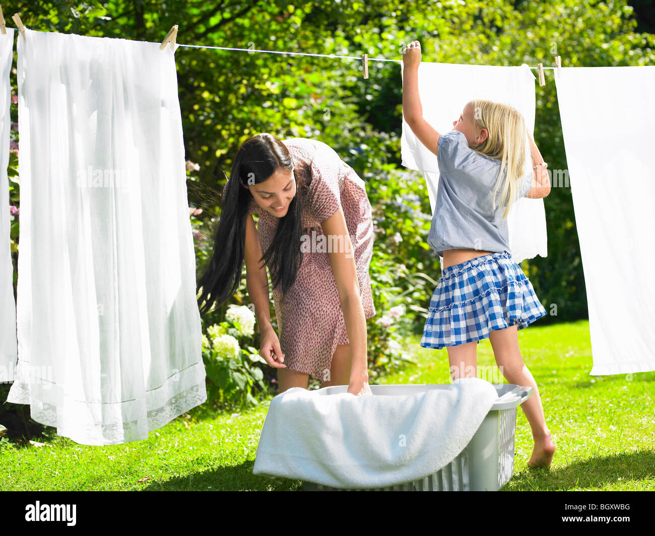 Mother and daughter doing the laundry Stock Photo - Alamy